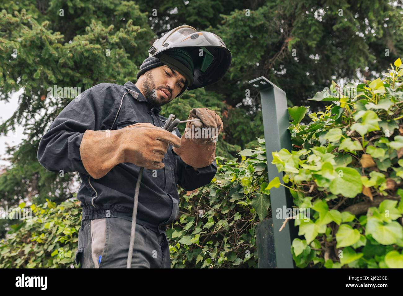 Welder standing with welding torch at construction site Stock Photo - Alamy