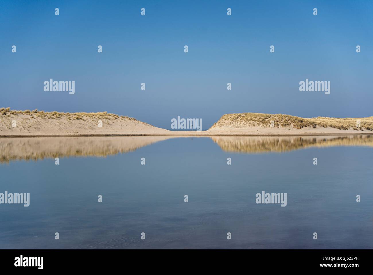 Lagoon with sand dunes under clear sky Stock Photo - Alamy