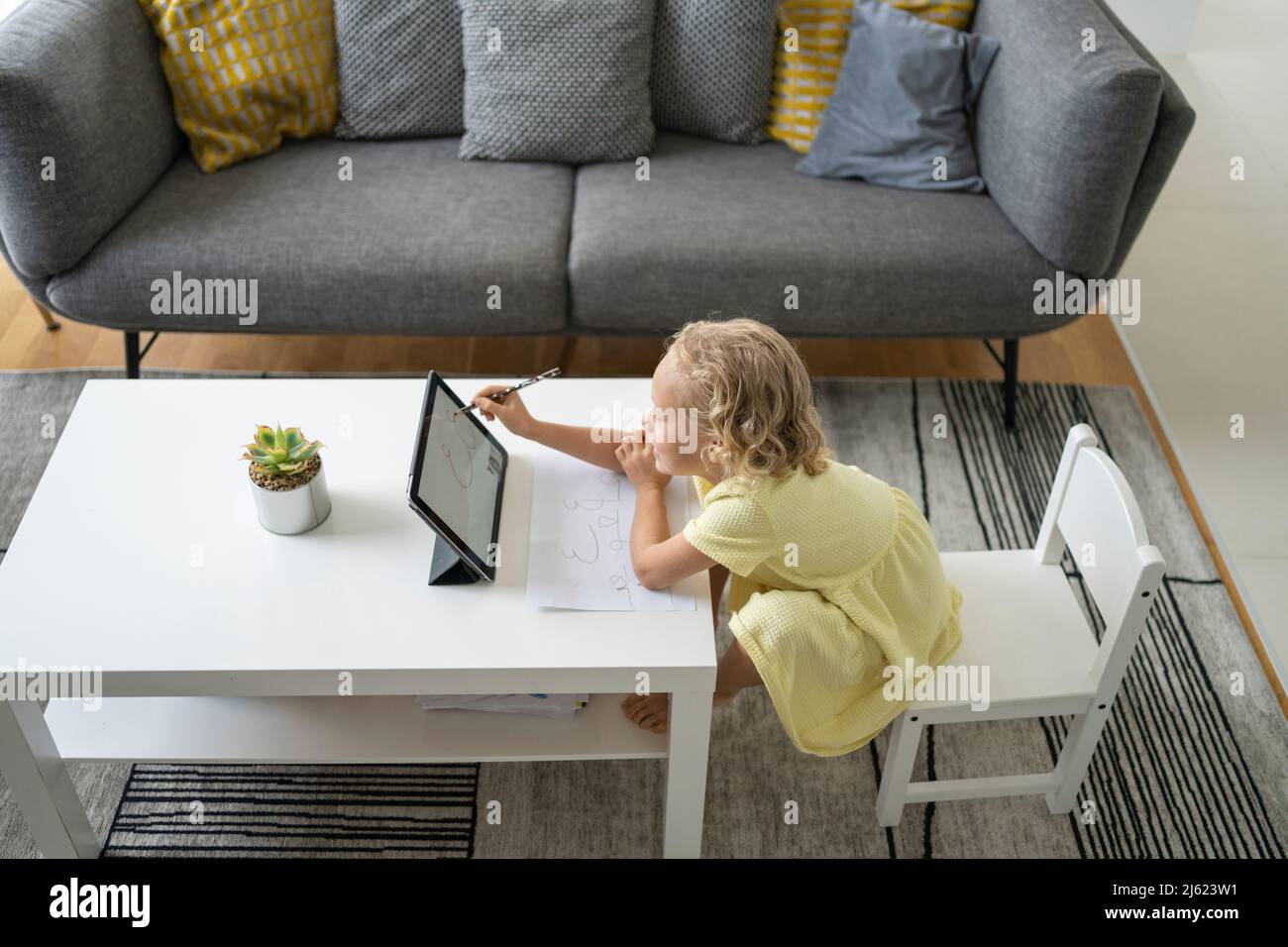 Child using pencil hi-res stock photography and images - Alamy
