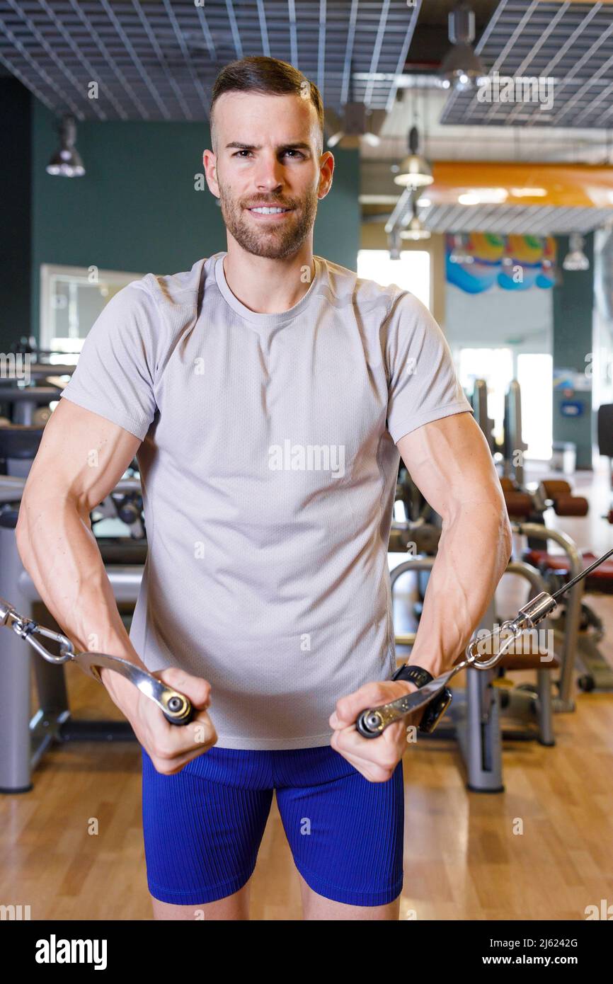 Smiling young man working out in gym Stock Photo - Alamy