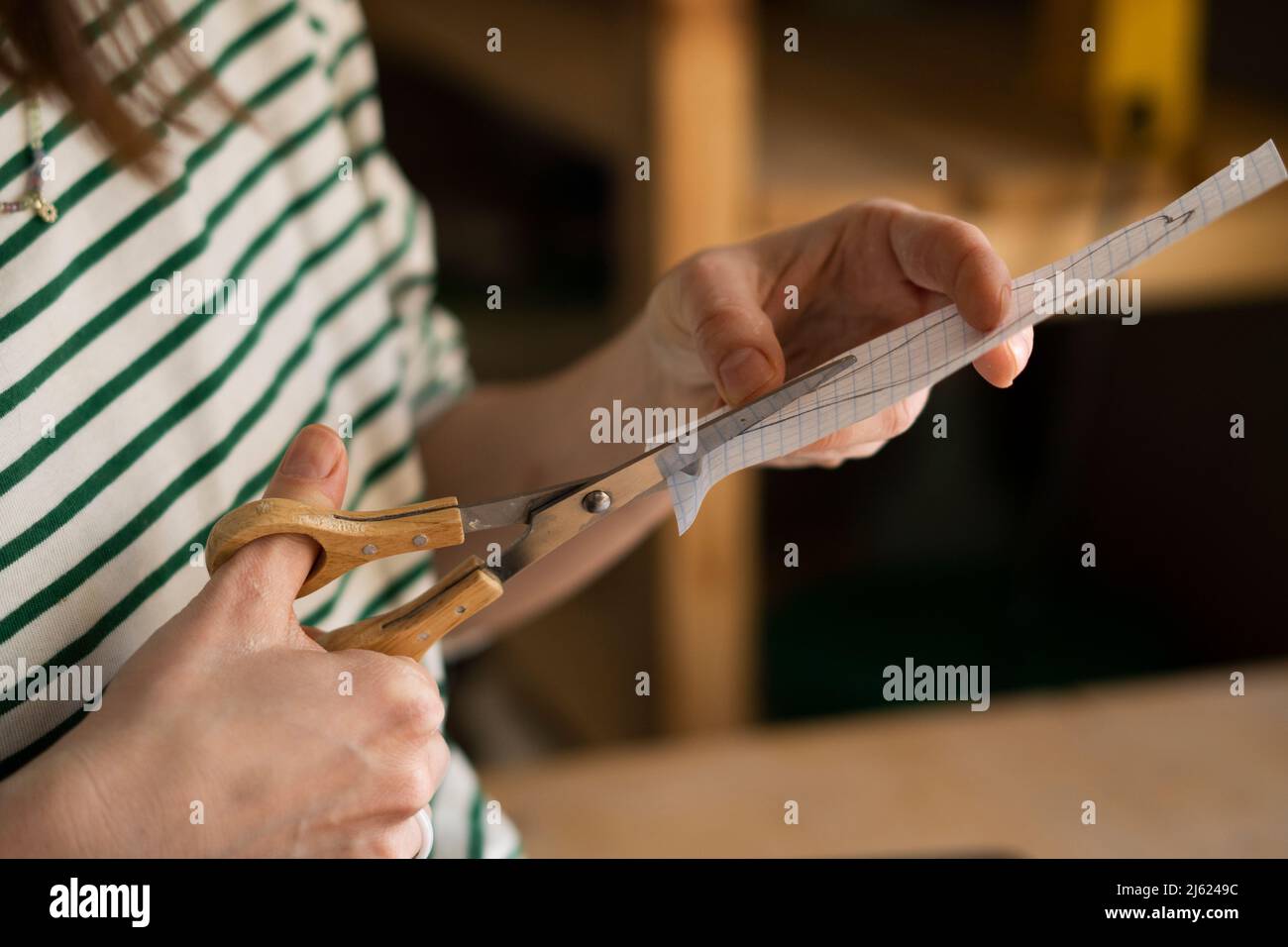 Woman cutting paper with scissor at workshop Stock Photo - Alamy