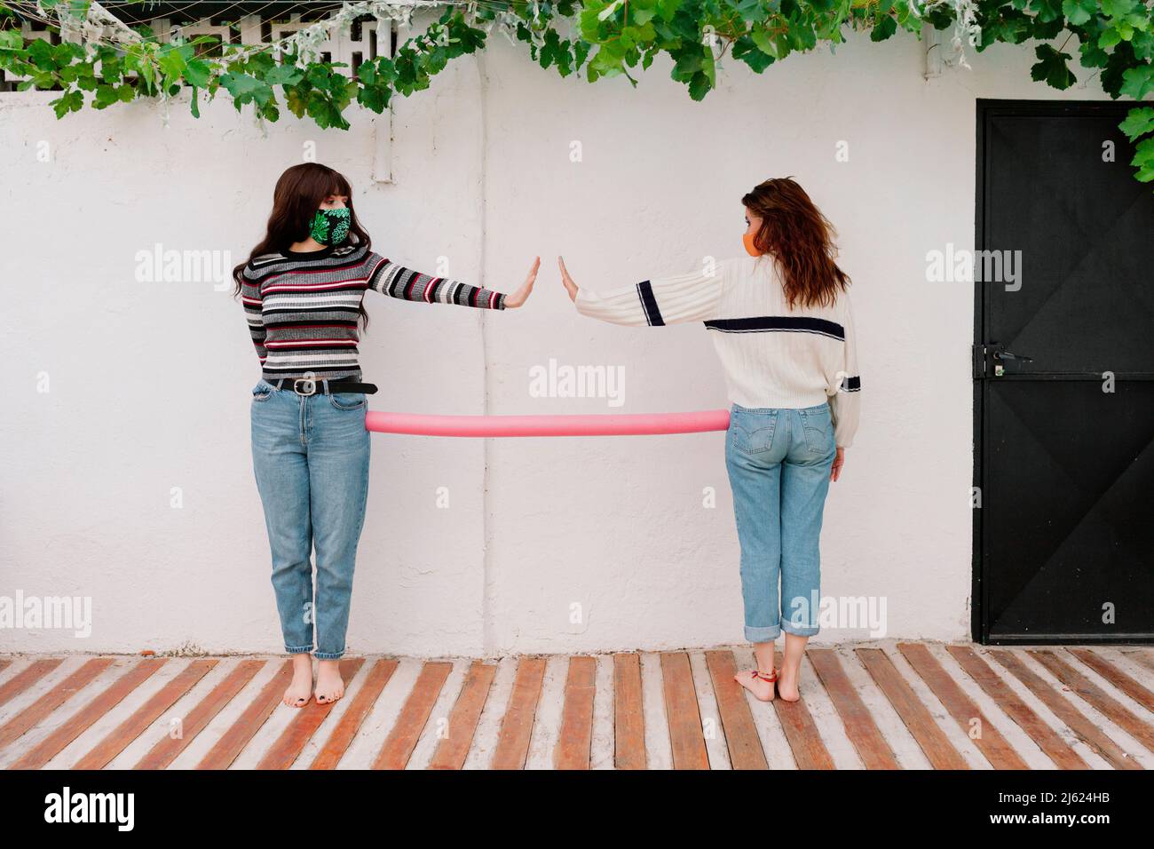 Friends social distancing with noodle float in back yard Stock Photo ...