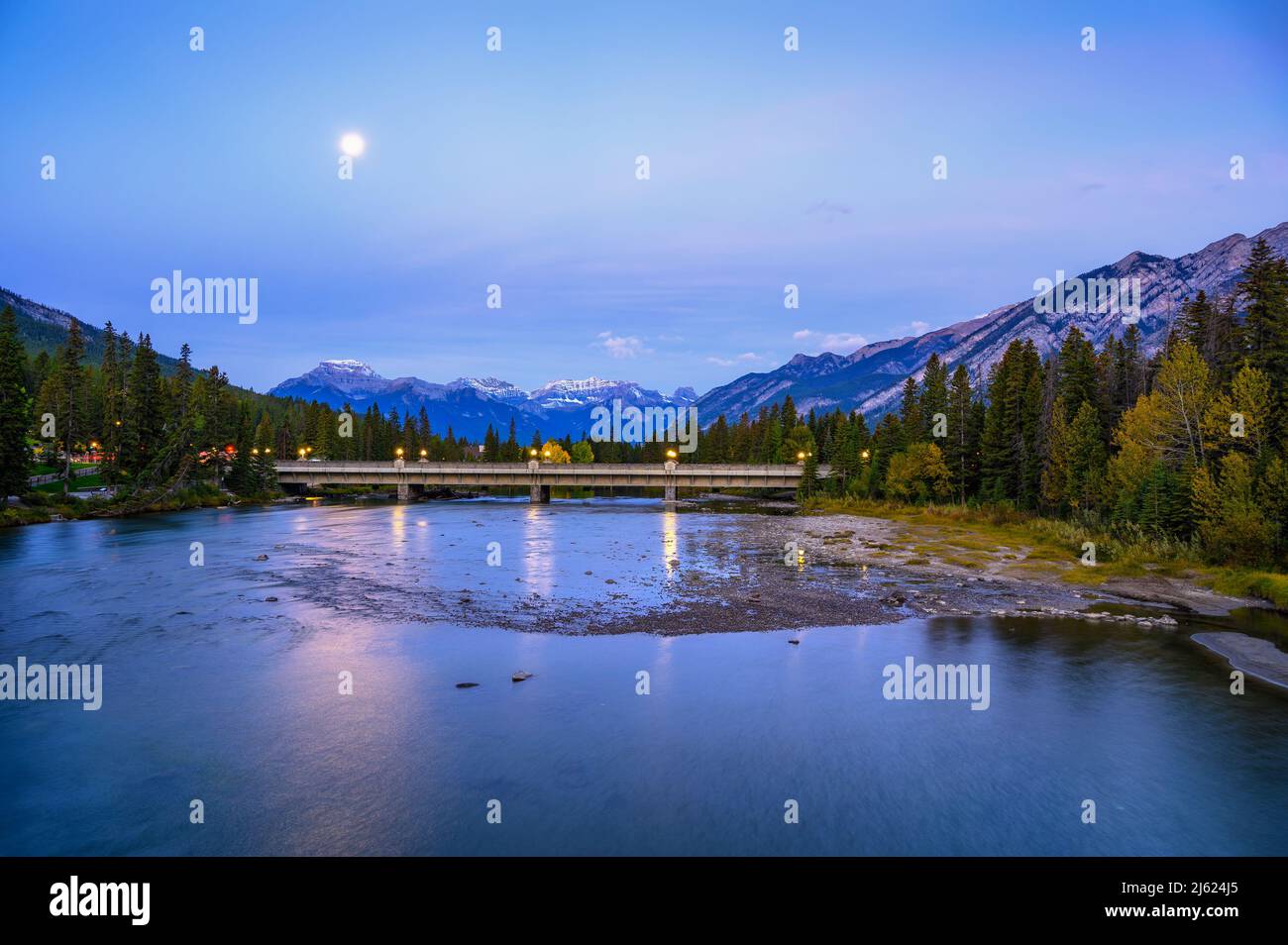 Moon over Banff Avenue Bridge and Bow River in Rocky Mountains, Canada ...