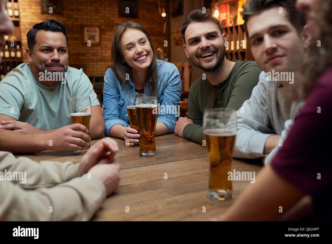 Group of friends having beer and socializing in a pub Stock Photo - Alamy