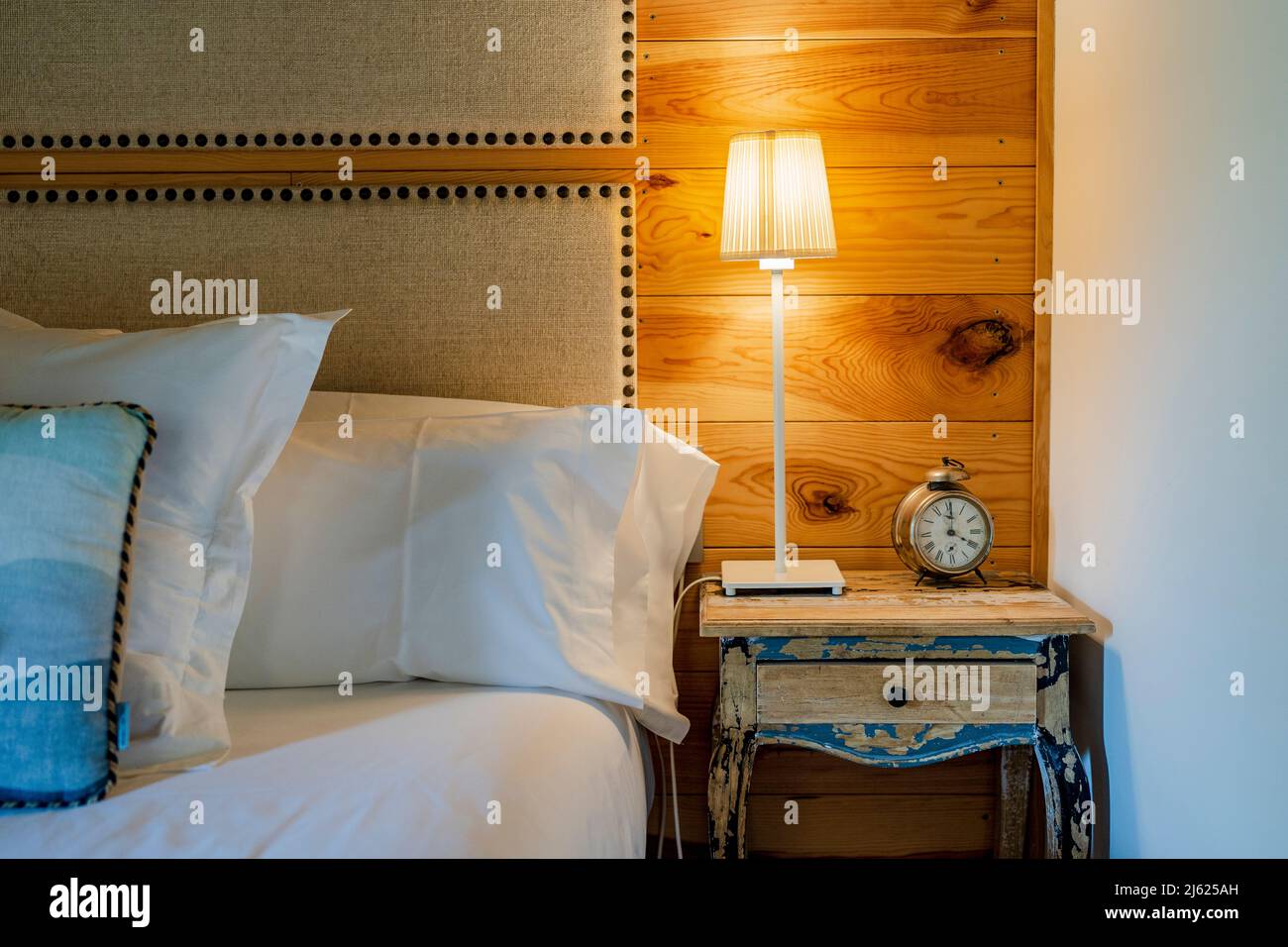 Illuminated lamp on night table in hotel Stock Photo - Alamy