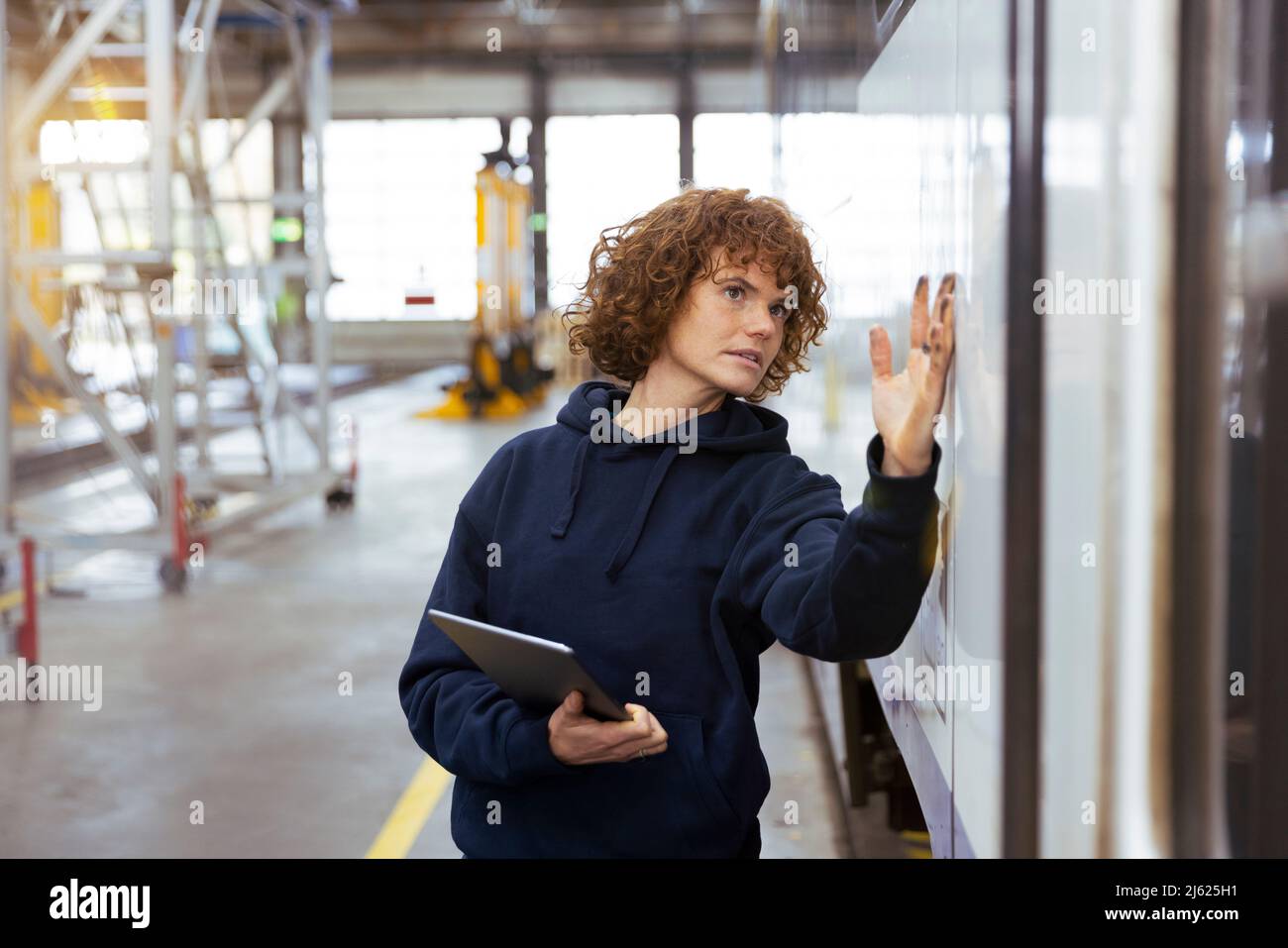 Engineer holding tablet PC analyzing monorail in factory Stock Photo ...