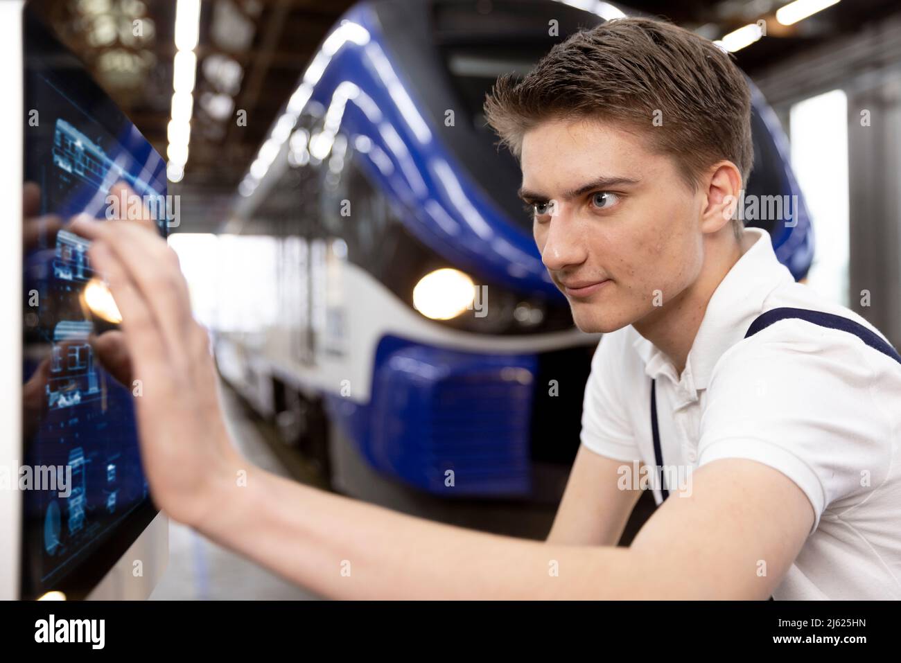 Trainee working on touch screen device in factory Stock Photo - Alamy