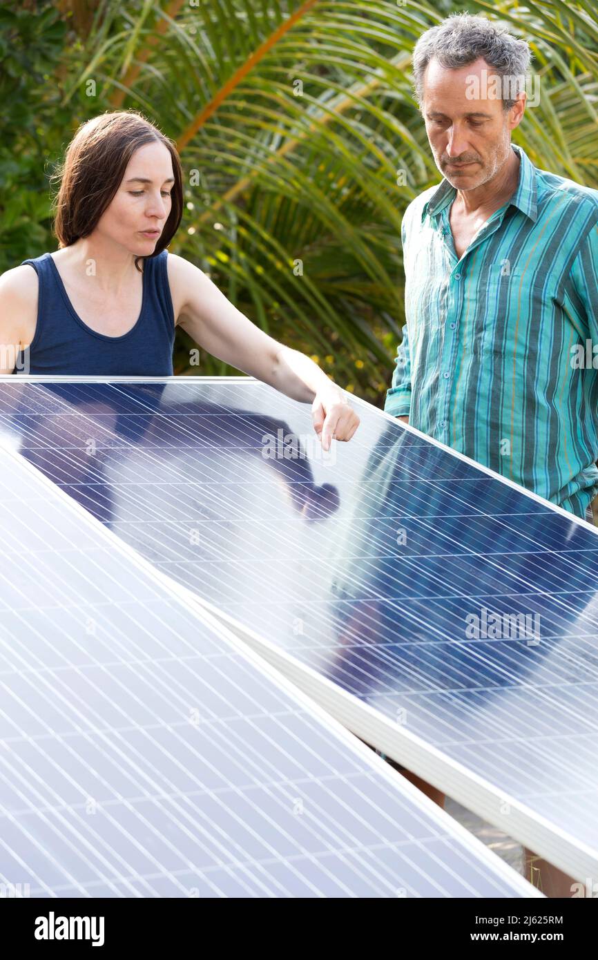 Woman discussing with man about solar panels Stock Photo - Alamy