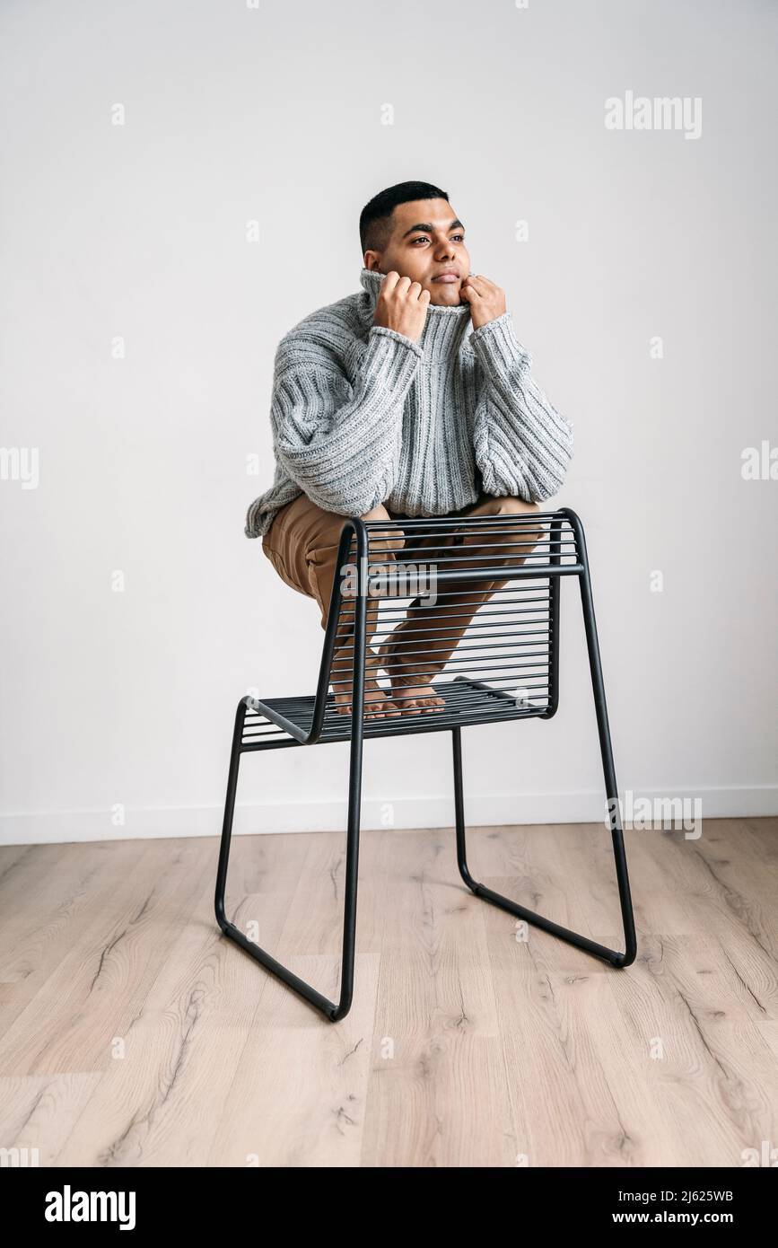 Indian man crouching on wall hi-res stock photography and images - Alamy