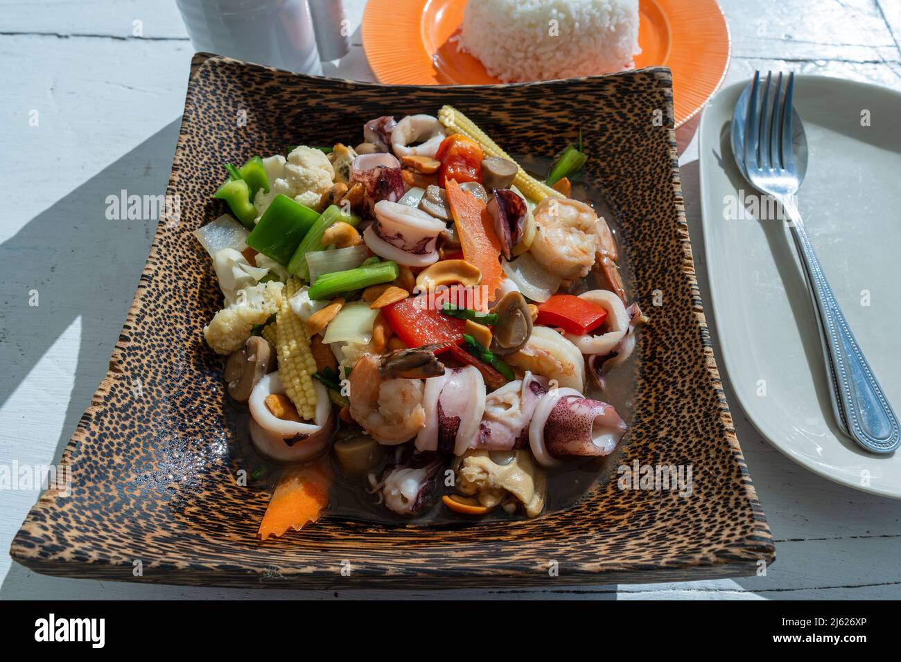 Stir fried cashew nut with seafood and vegetable in plate, close up ...