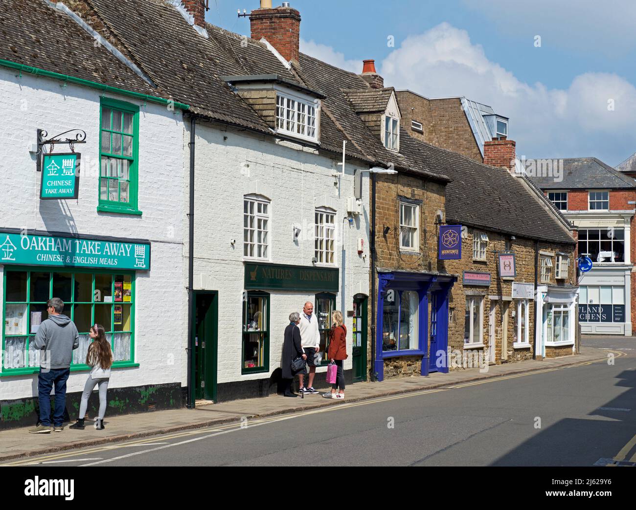People chatting - and window shopping - on Mill Street, Oakham, Rutland ...