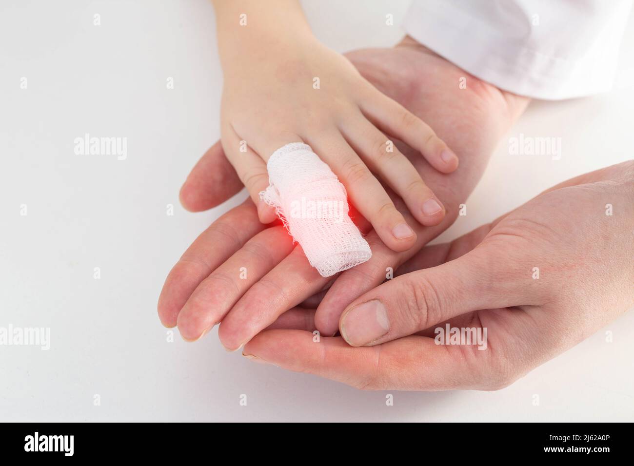 The hands of the doctor bandage the sore finger with a bandage of the ...
