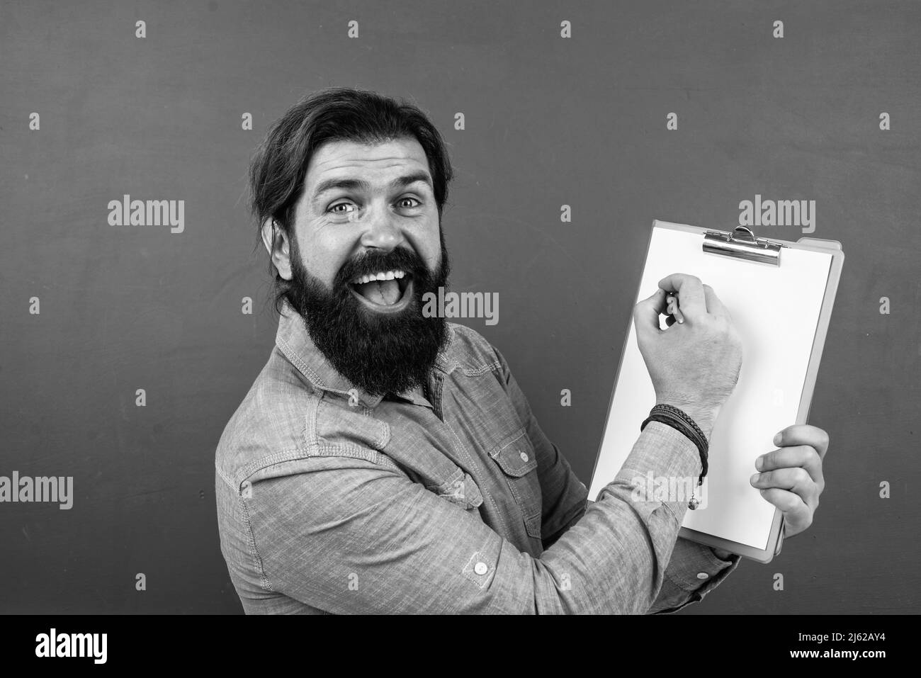 good looking man with beard and moustache showing document paper for ...