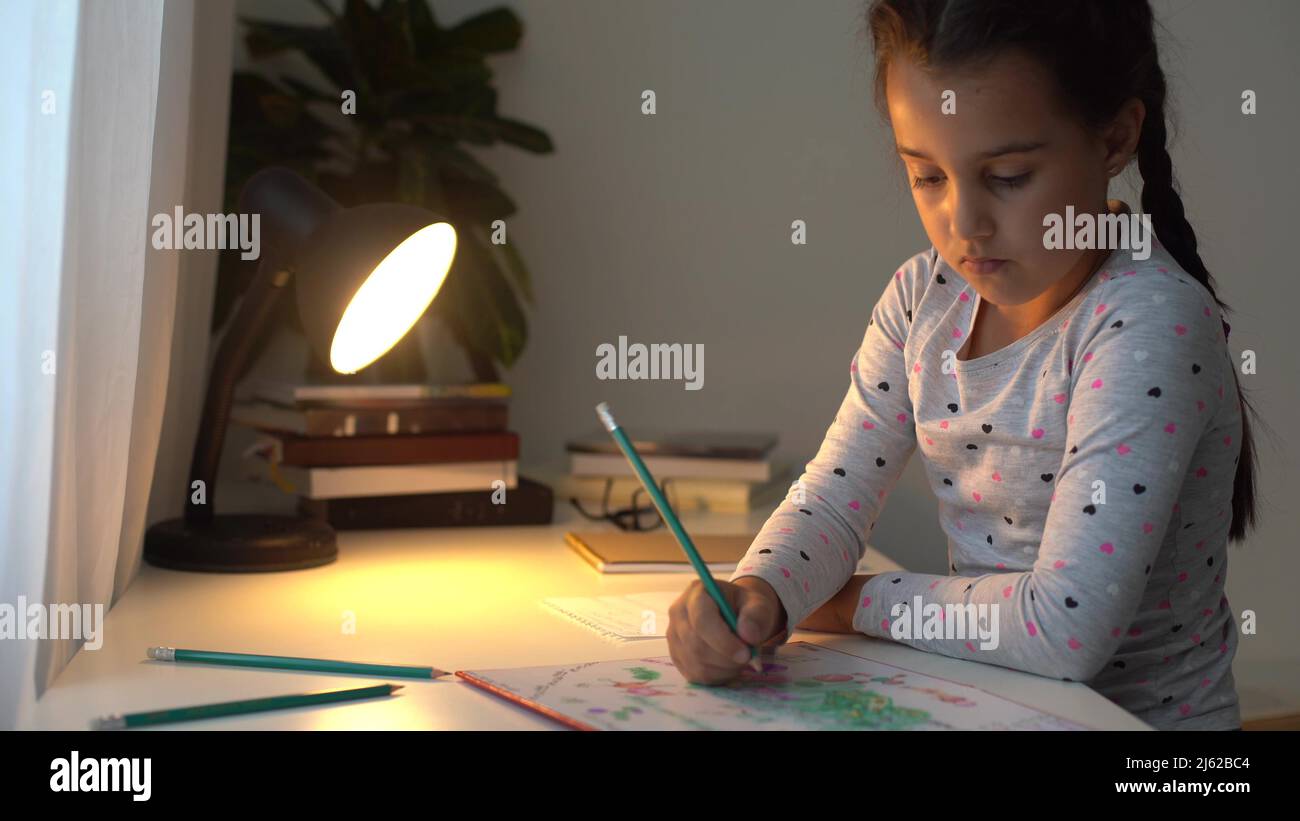 Cute smart primary school child girl learning writing doing math ...