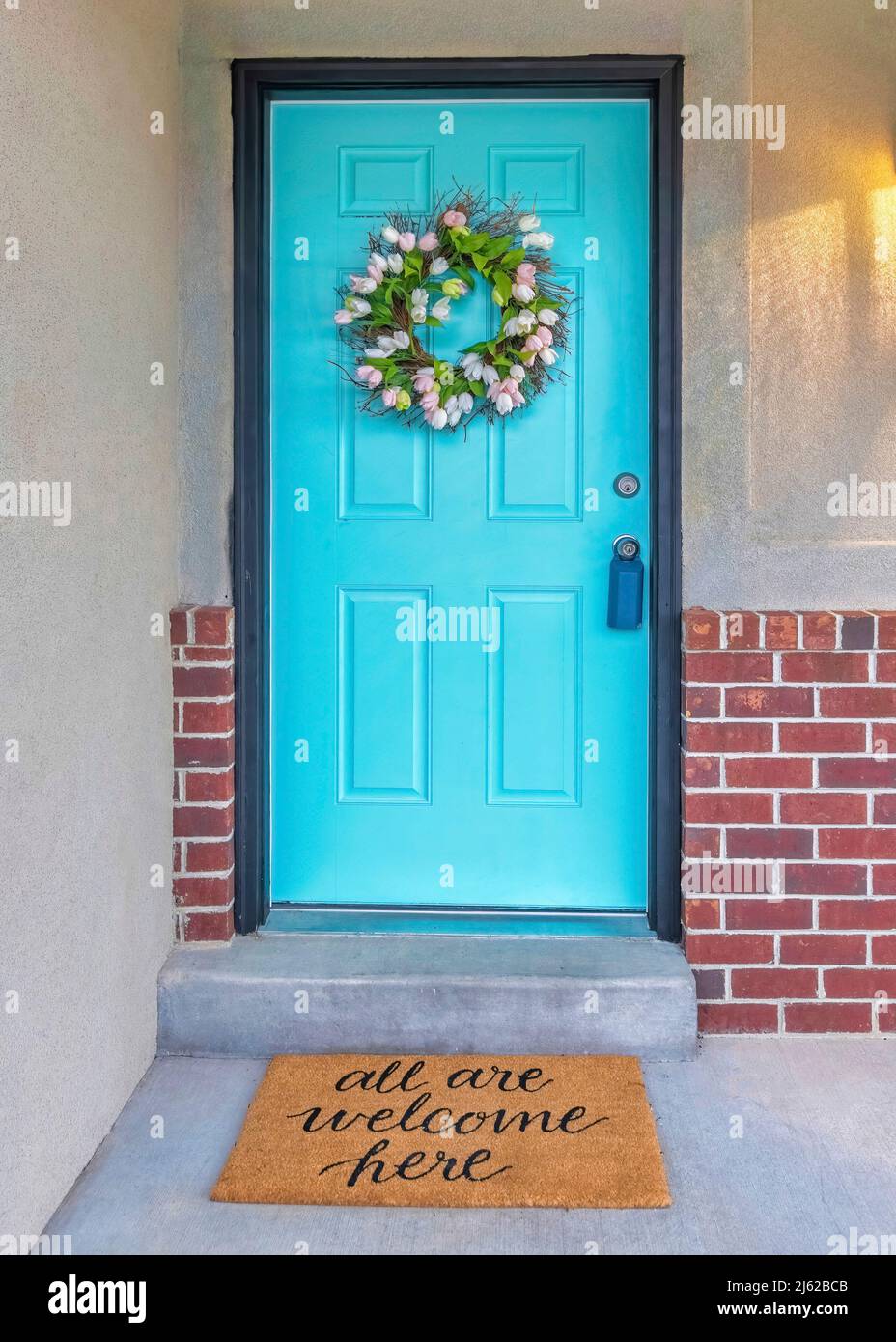 Vertical House exterior with red bricks and cyan front door with ...