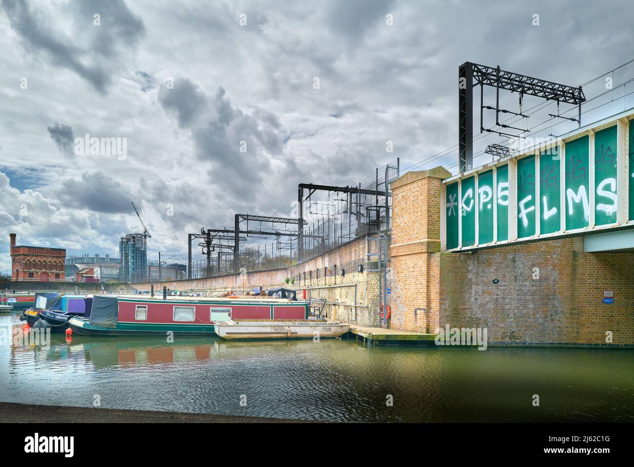 Canal boats moored at the St Pancras basin of the Regent canal beside ...
