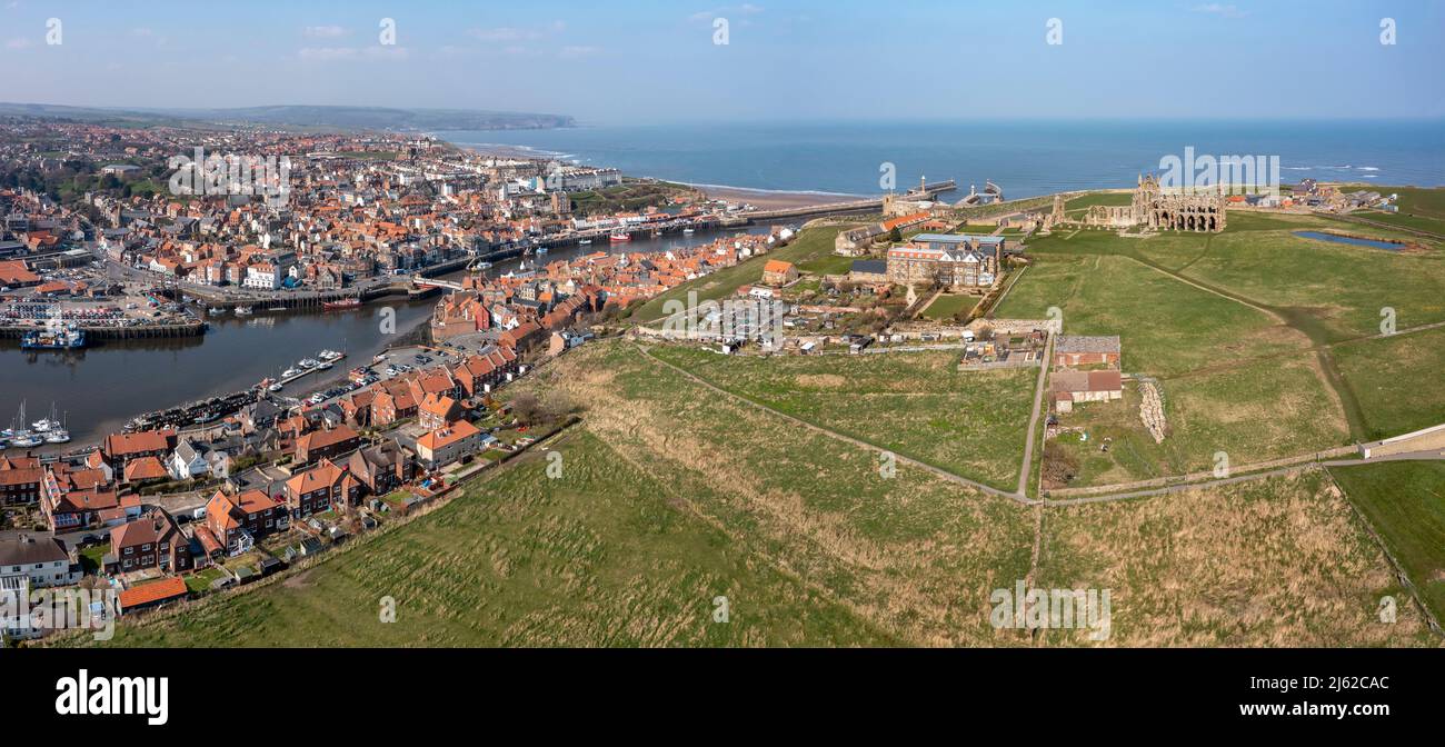 Elevated panorama of Whitby harbour town abbey and church headland ...