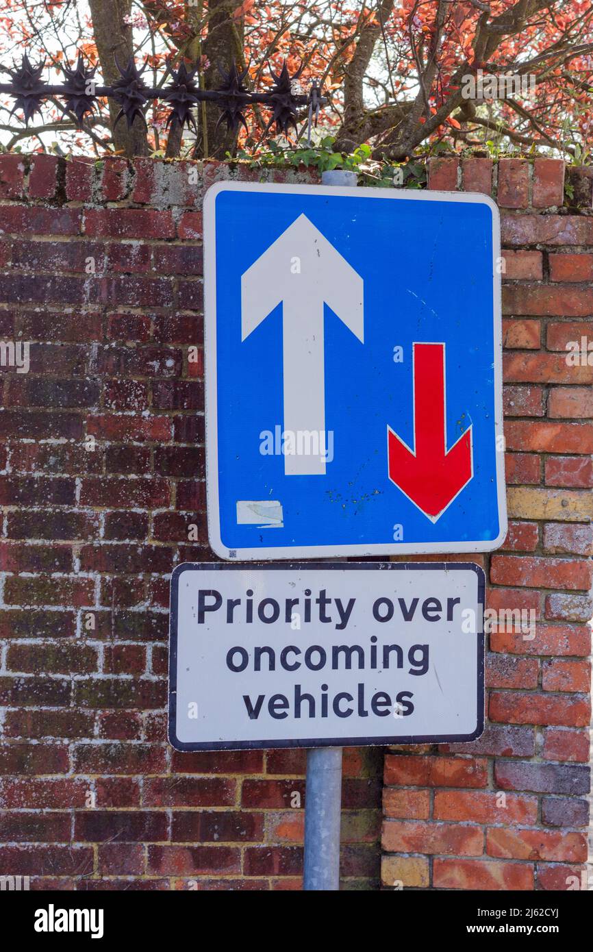 Priority over oncoming vehicles UK road sign Stock Photo - Alamy