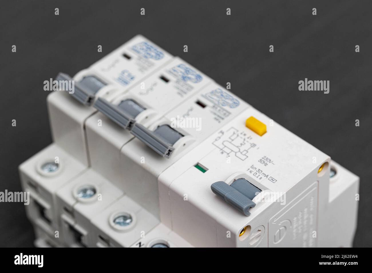 Electrical circuit breakers on a gray background, close-up. Designed ...