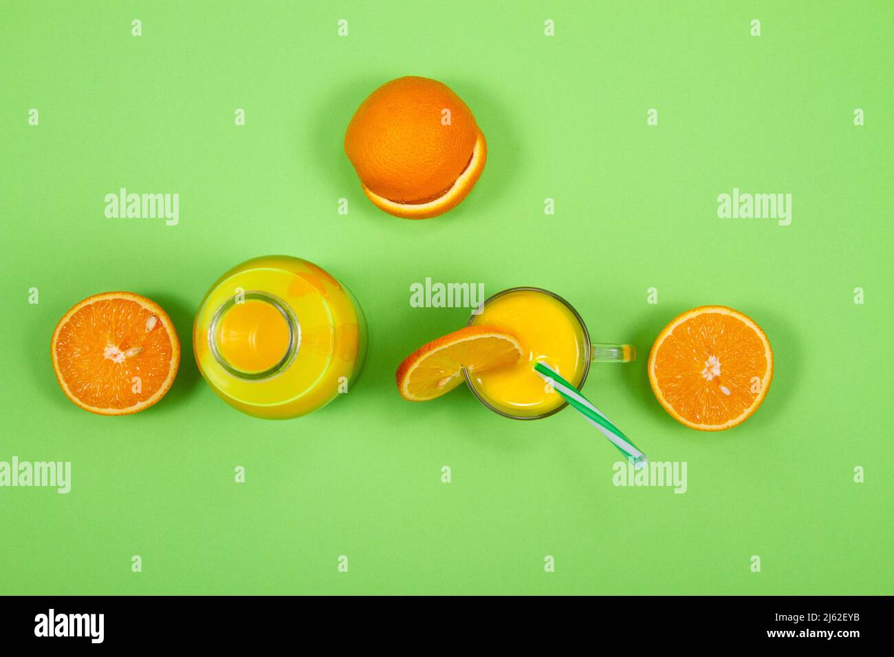 Glass of orange juice from above on bright green background Stock Photo ...