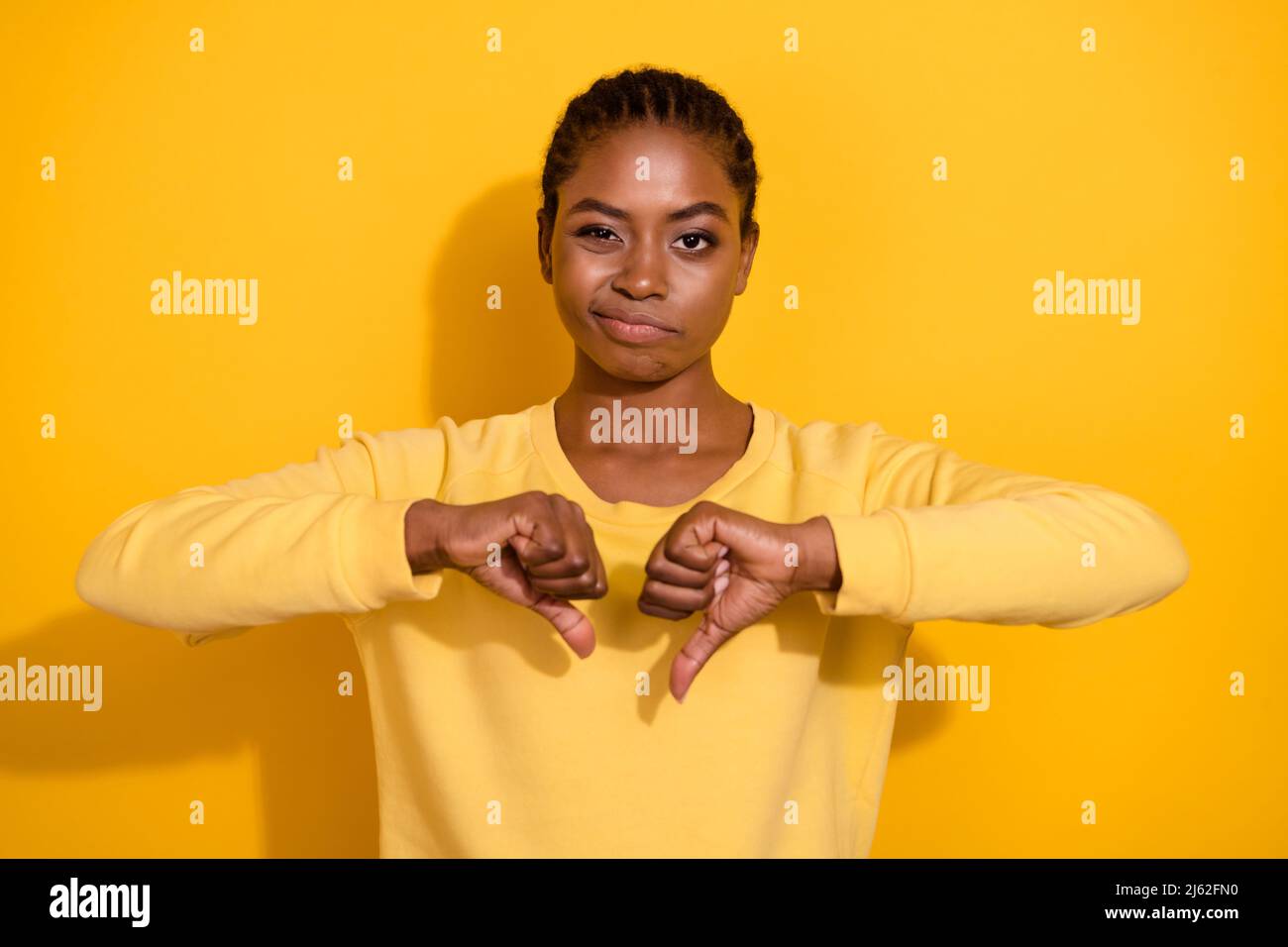 Portrait of attractive skeptic girl showing thumb down dislike no ...