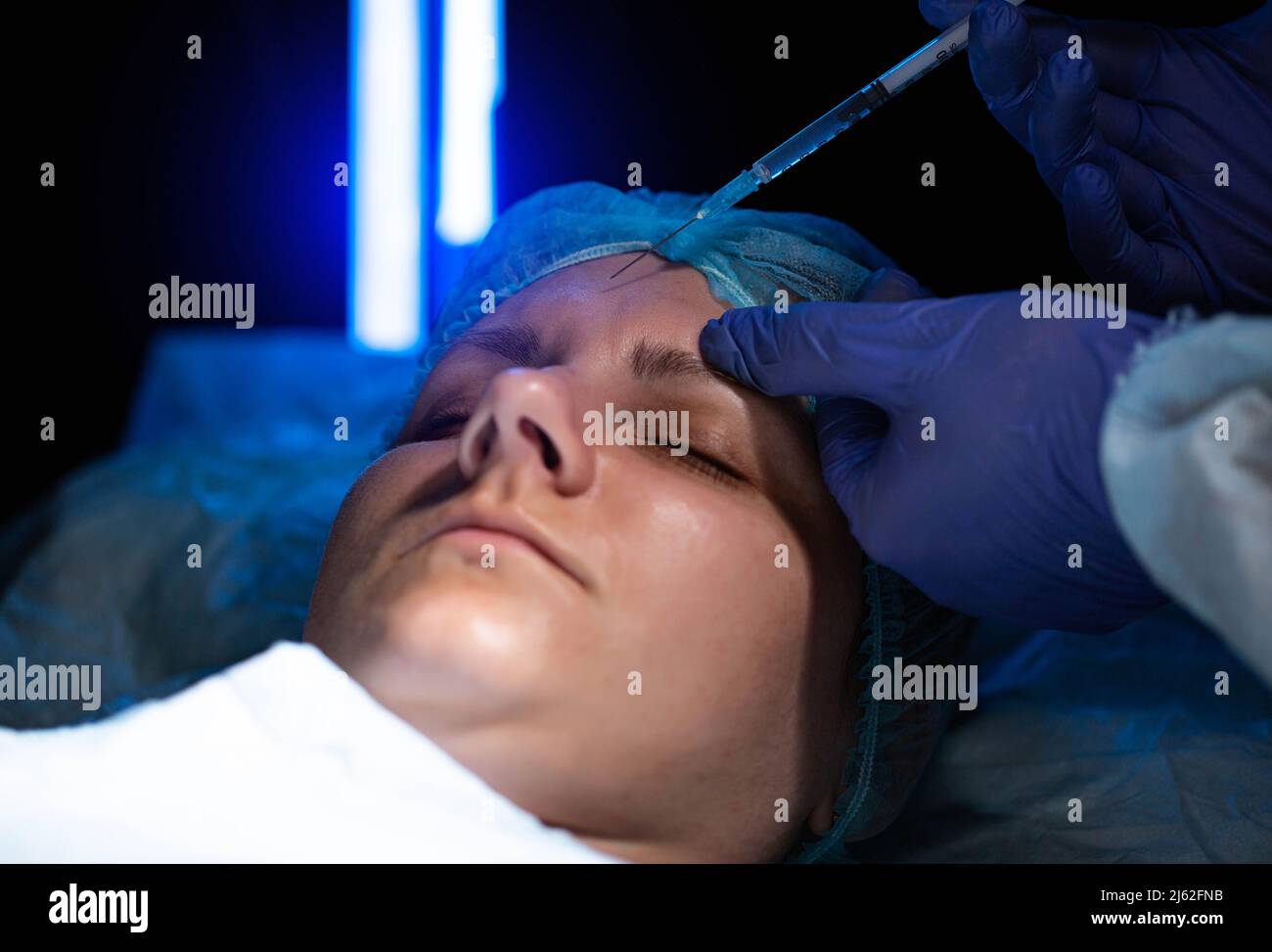 Doctor cosmetologist makes beauty injections to smooth forehead ...