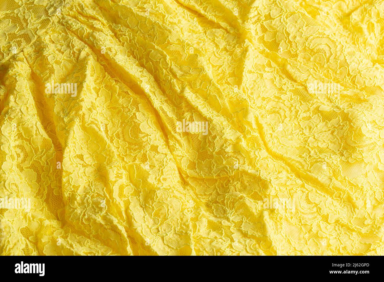 Yellow wrinkled modern fabric on the dress, macro. Fashion, textured ...