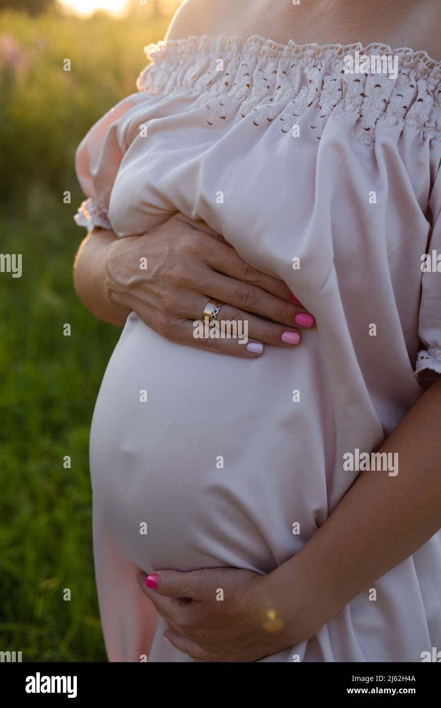 tender pregnancy portrait on sunset. expecting mother to be outside in ...