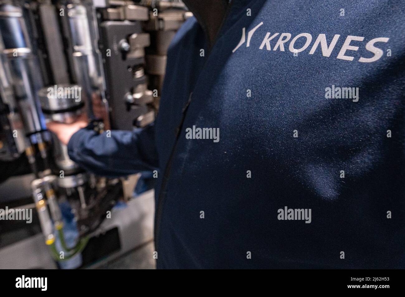 Neutraubling, Germany. 25th Apr, 2022. A Krones AG employee works on a ...