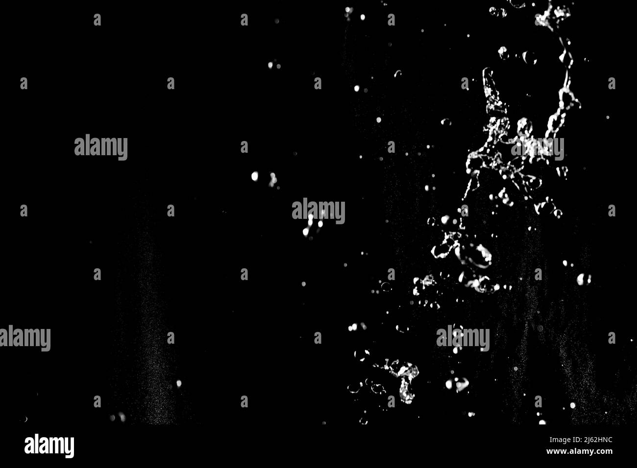 water splashes isolated on black background. white jets with drops ...