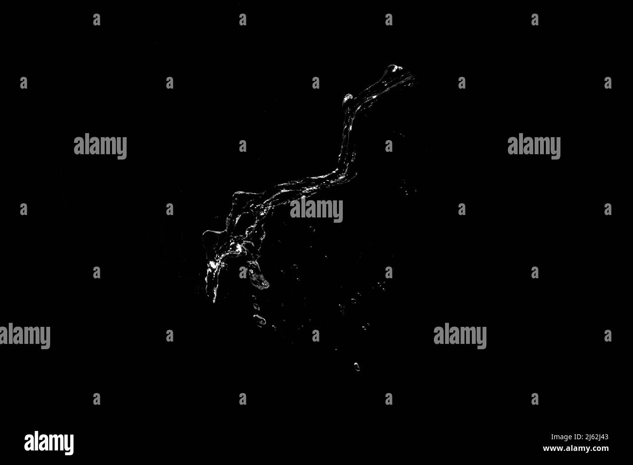 water splashes isolated on black background. white jets with drops ...