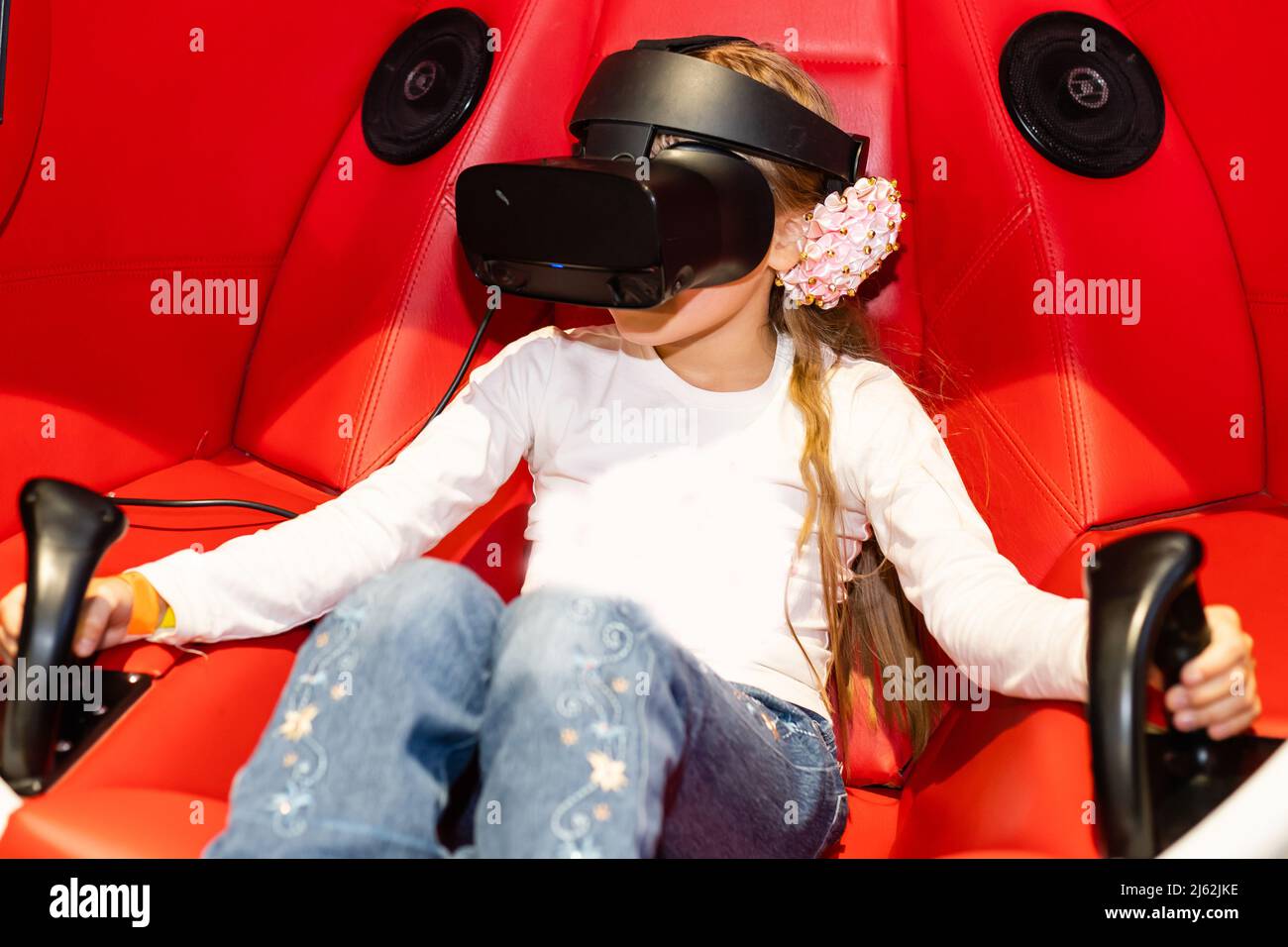 Child with virtual reality headset sitting in a chair booth Stock Photo ...