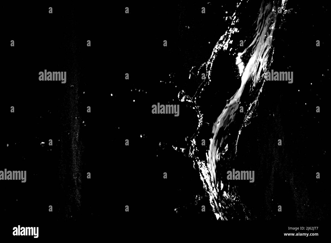 water splashes isolated on black background. white jets with drops ...