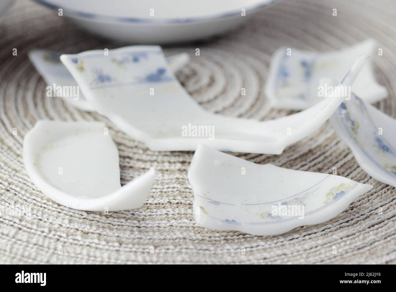 broken empty plate on a table Stock Photo - Alamy