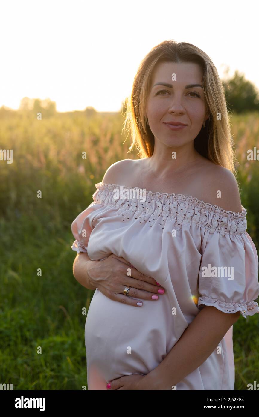 tender pregnancy portrait on sunset. expecting mother to be outside in ...