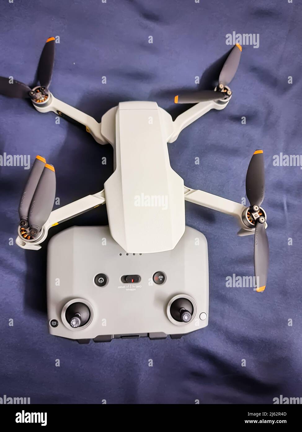 drone quad copter with its remote and dark blue background from ...