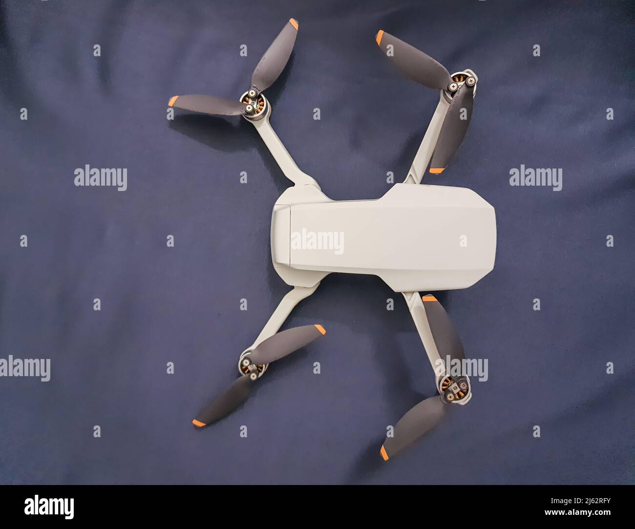 drone quad copter with its remote and dark blue background from ...