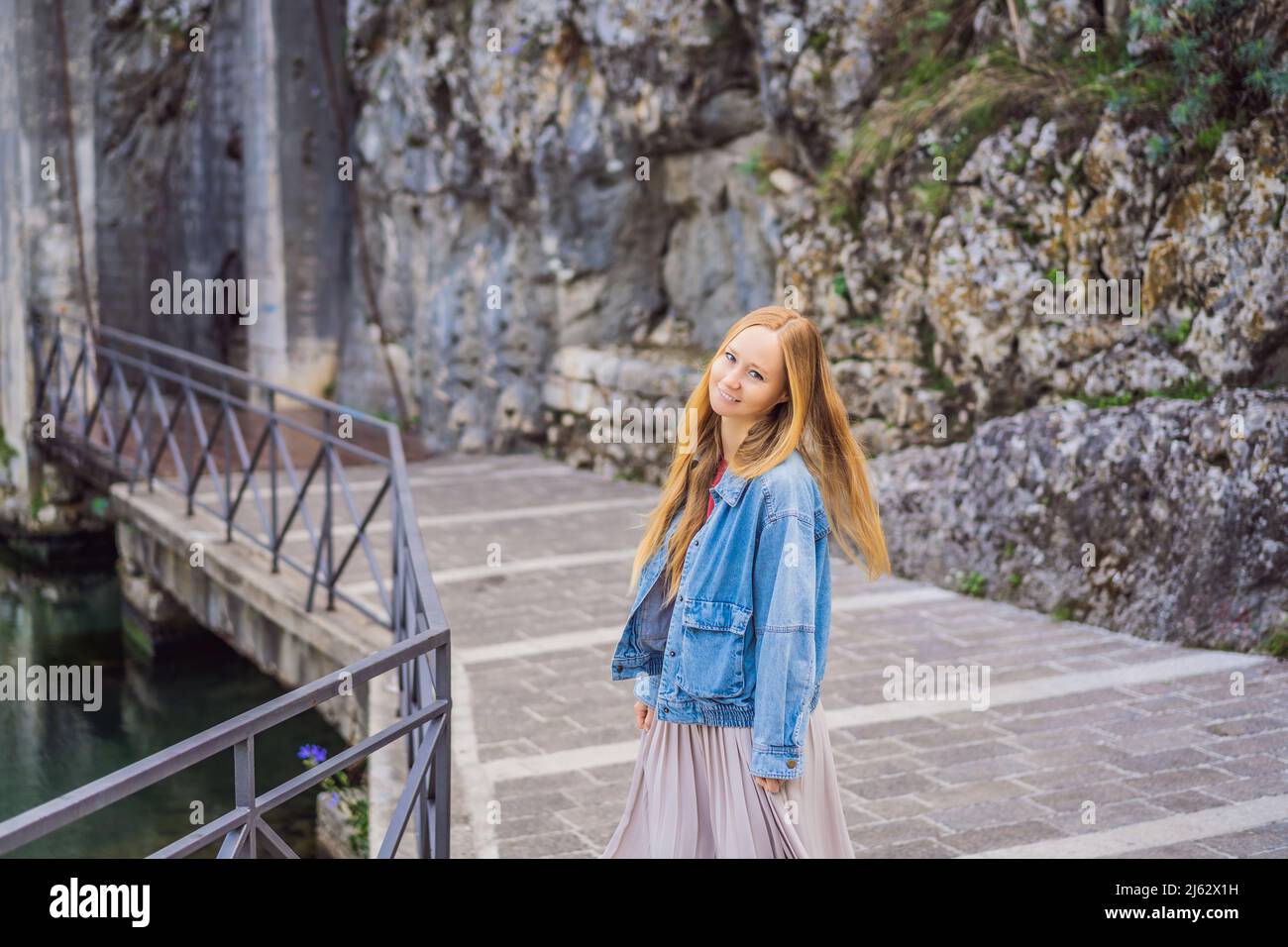 Woman tourist enjoying Colorful street in Old town of Kotor on a sunny ...