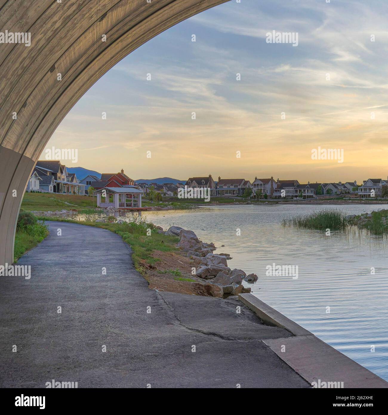 Square Whispy white clouds Under an arched bridge over Oquirrh Lake at ...