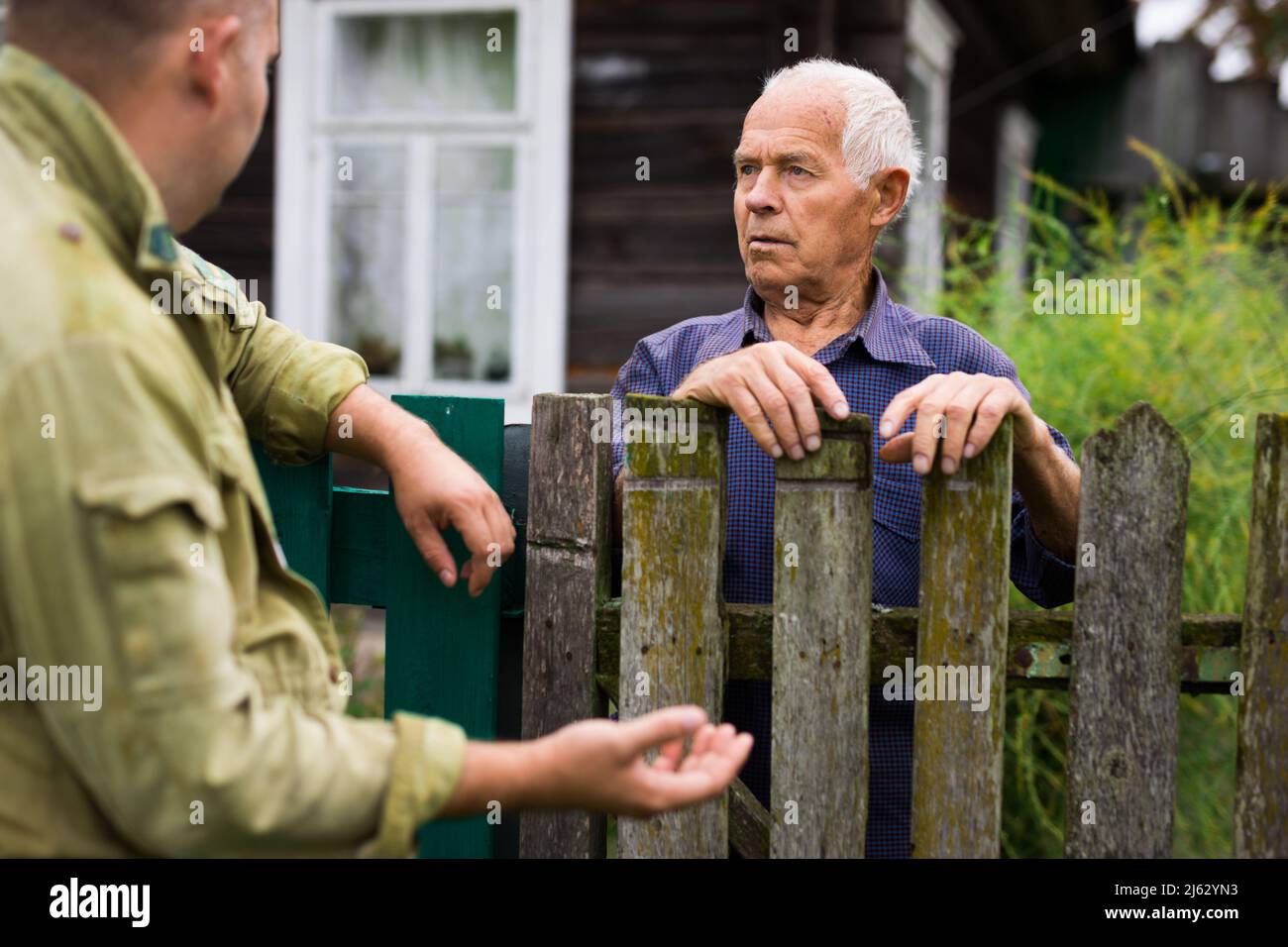 Senior man having conversation with his neighbour Stock Photo - Alamy