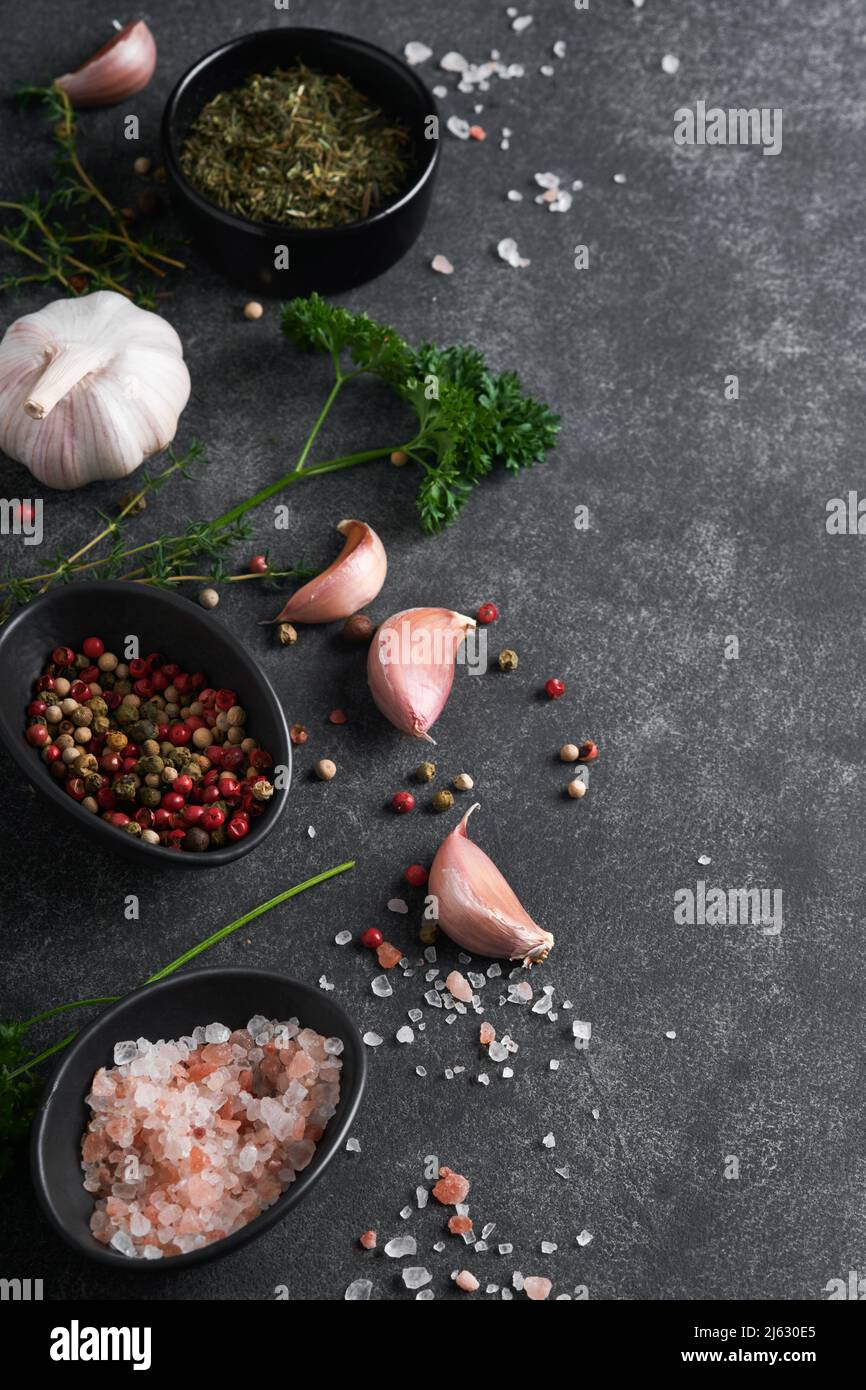 Black food cooking background. Stone texture with sea salt, pepper ...