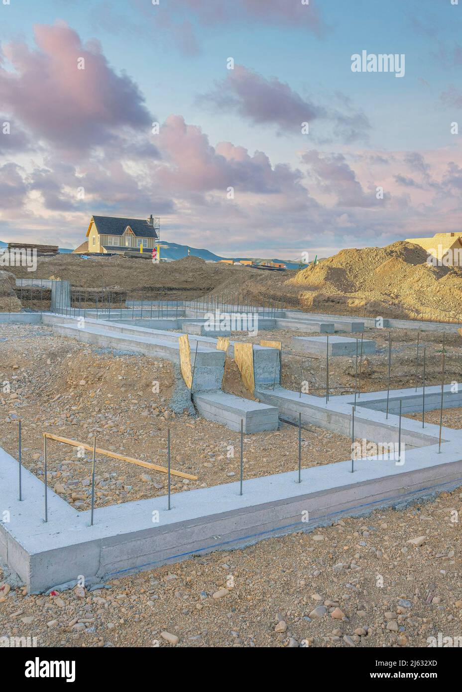 Vertical Puffy clouds at sunset Concrete foundation of a house at the ...