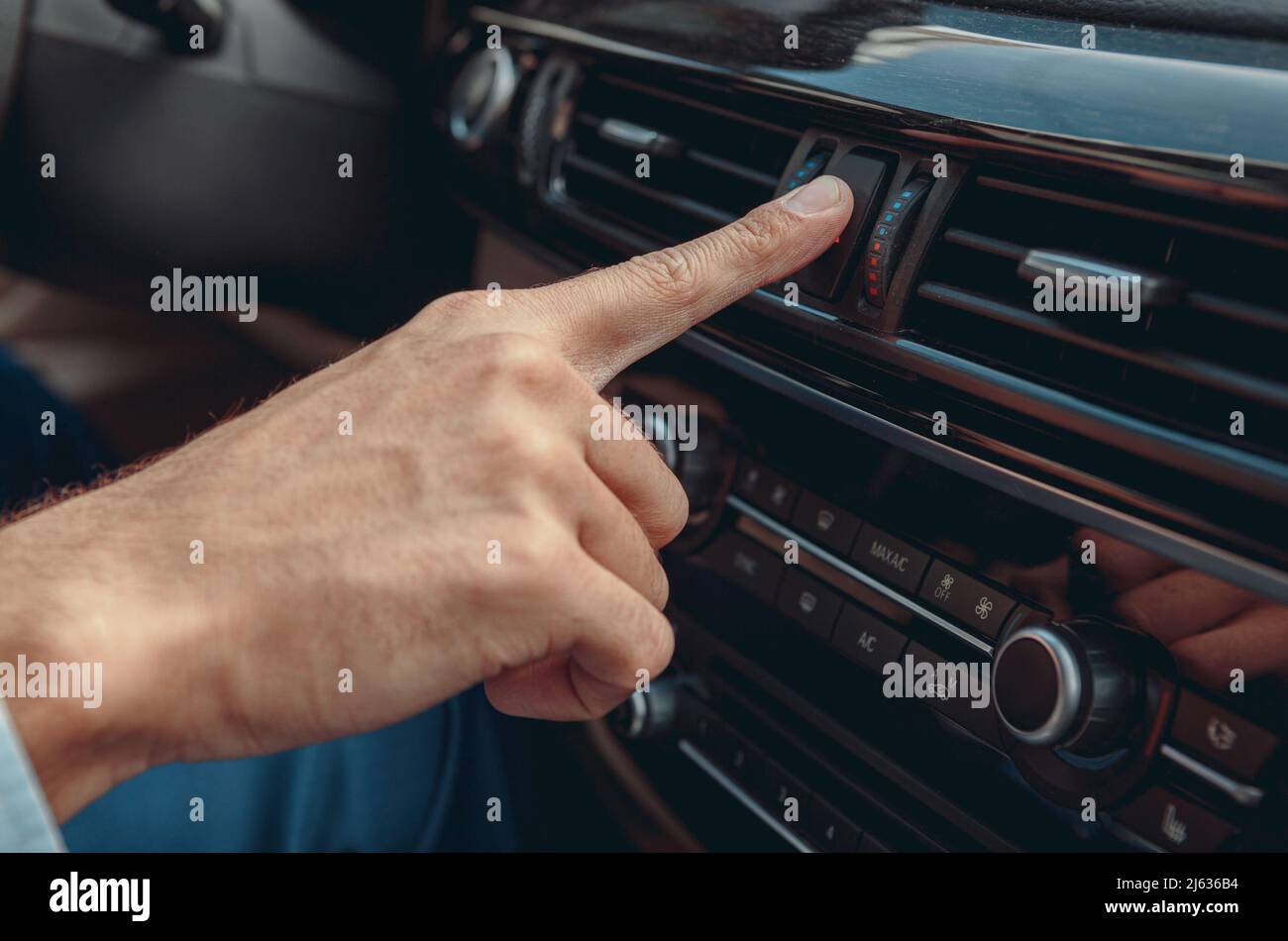 Male hand pushing button in his automobile Stock Photo - Alamy