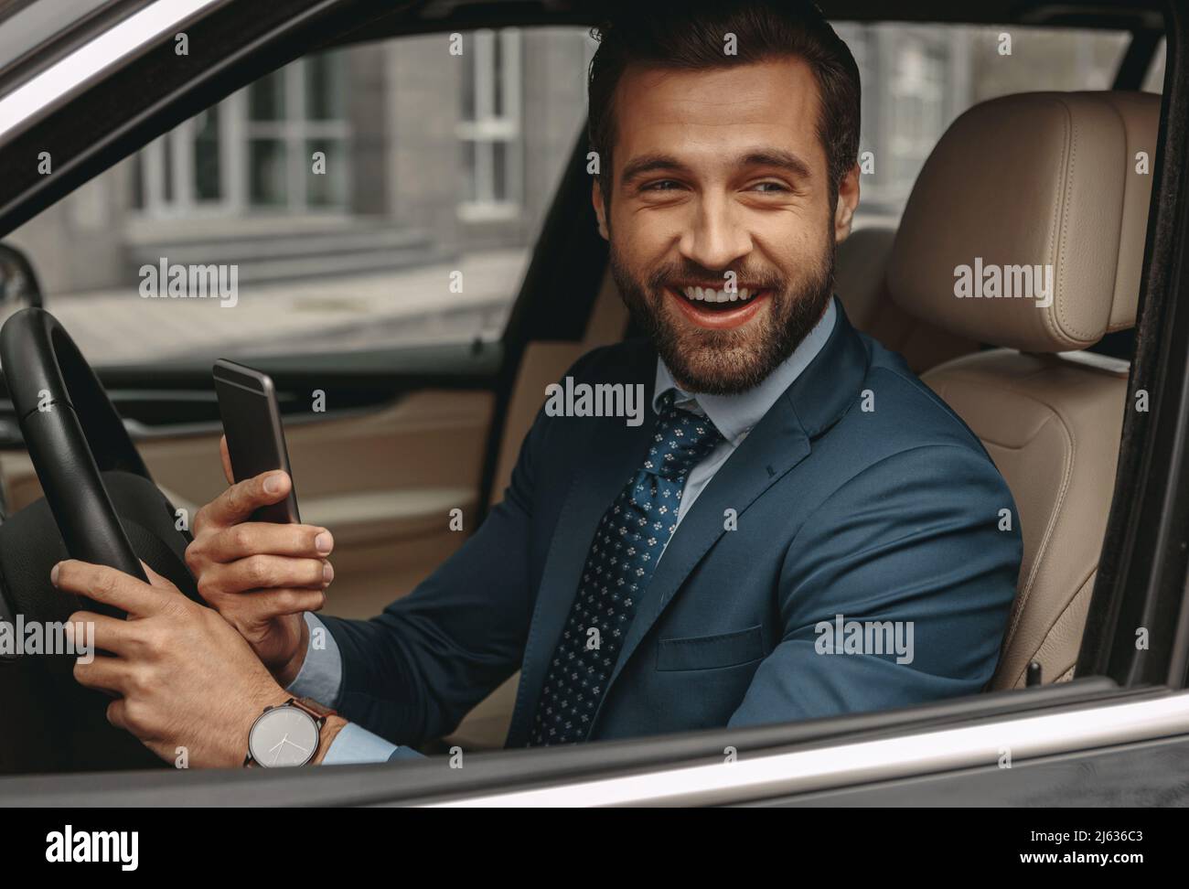 Handsome man driving holding steering hi-res stock photography and ...