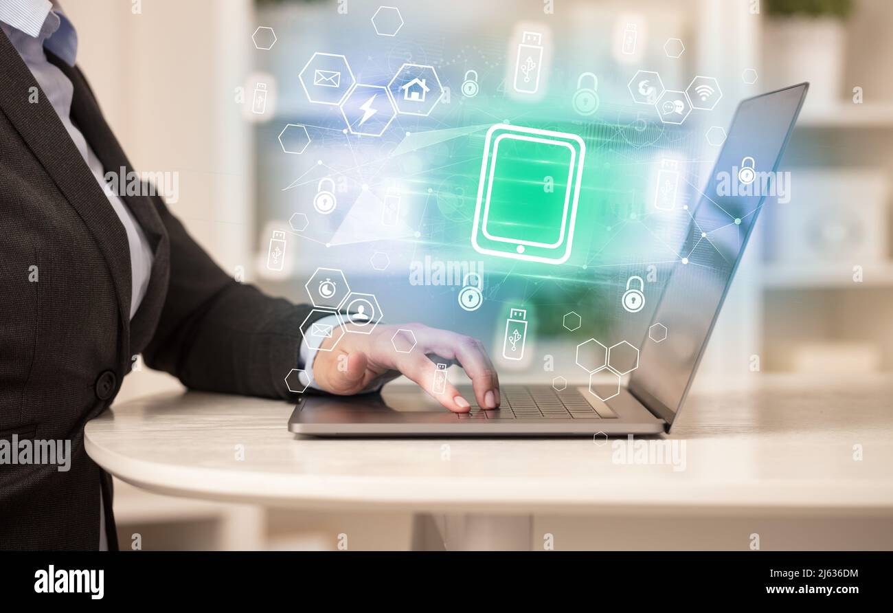 Hands working on laptop with digital icons Stock Photo - Alamy
