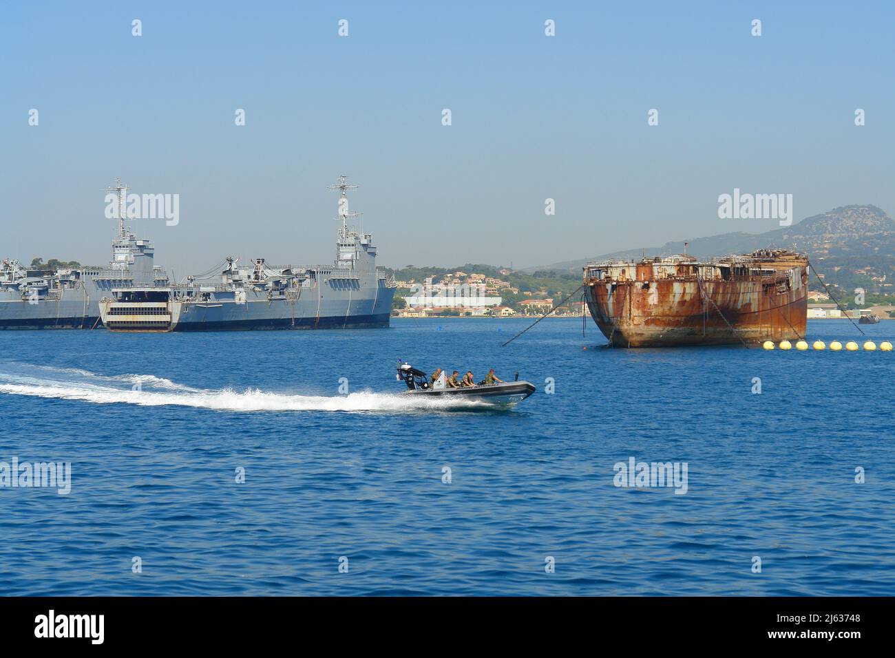 Marine commando surveillance patrol in the harbor of Toulon with behind ...