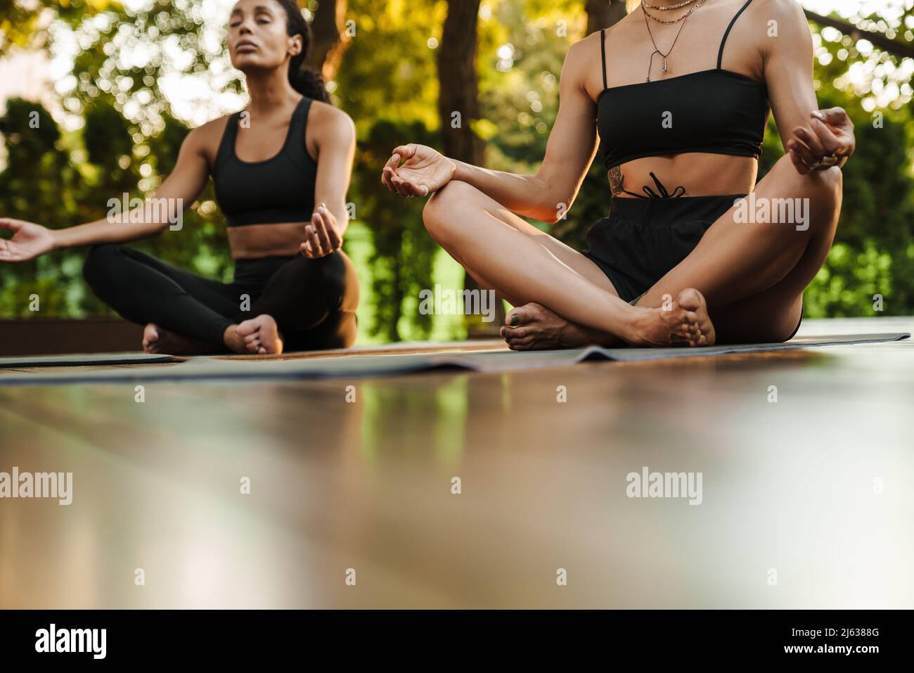 Two young women practice yoga hi-res stock photography and images - Alamy