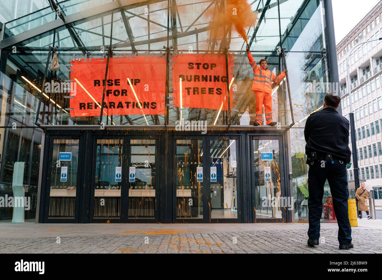 London, UK. 27 April 2022. Protestor from Axe Drax spray paint to the ...