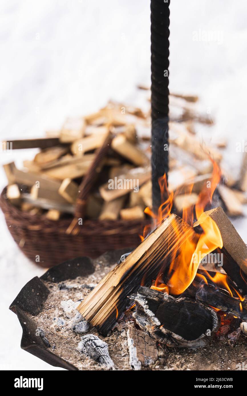 Firewood burning inside the fire-pit during cold winter day Stock Photo ...