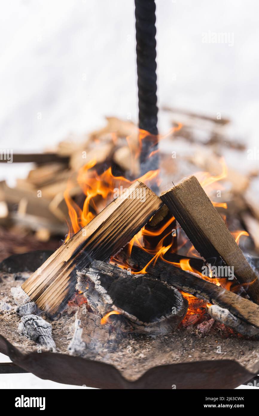 Firewood burning inside the fire-pit during cold winter day Stock Photo ...